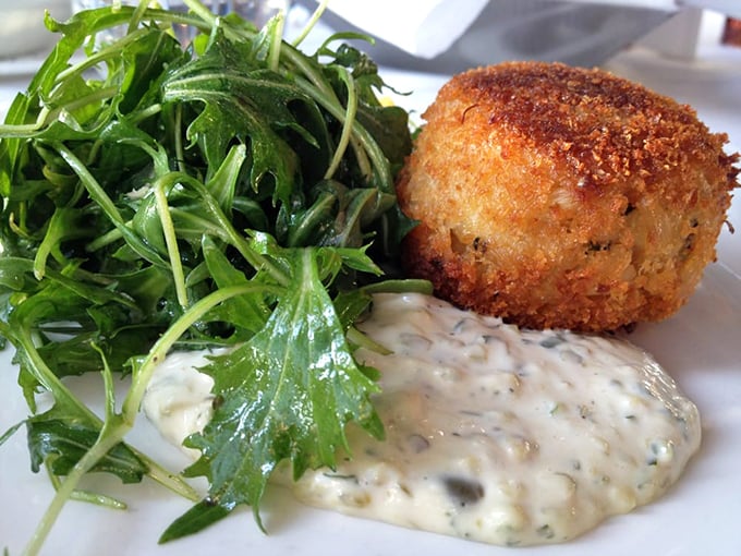 A perfectly golden crab cake that doesn't hide behind fillers—like that friend who always tells you the honest truth, but deliciously.