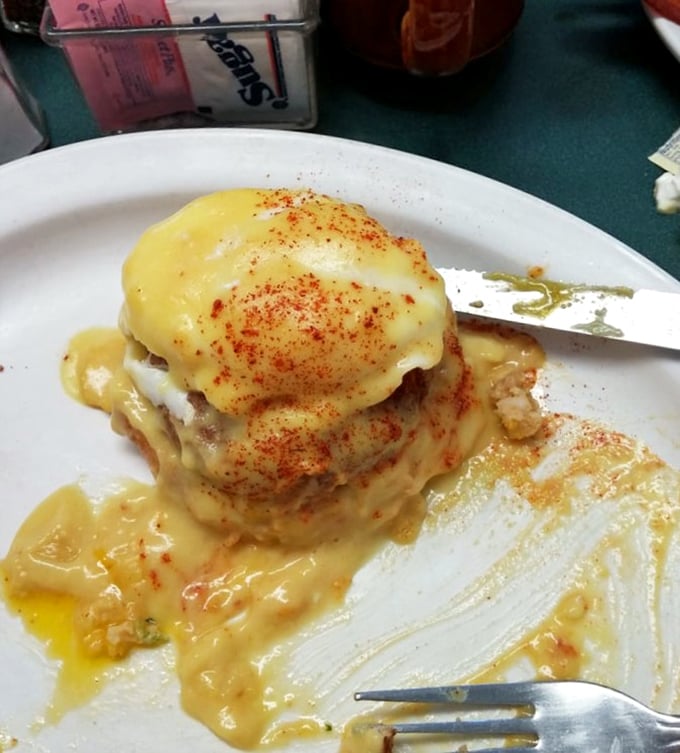 This isn't just breakfast, it's architecture—a towering achievement of culinary engineering where hollandaise cascades like a buttery waterfall.