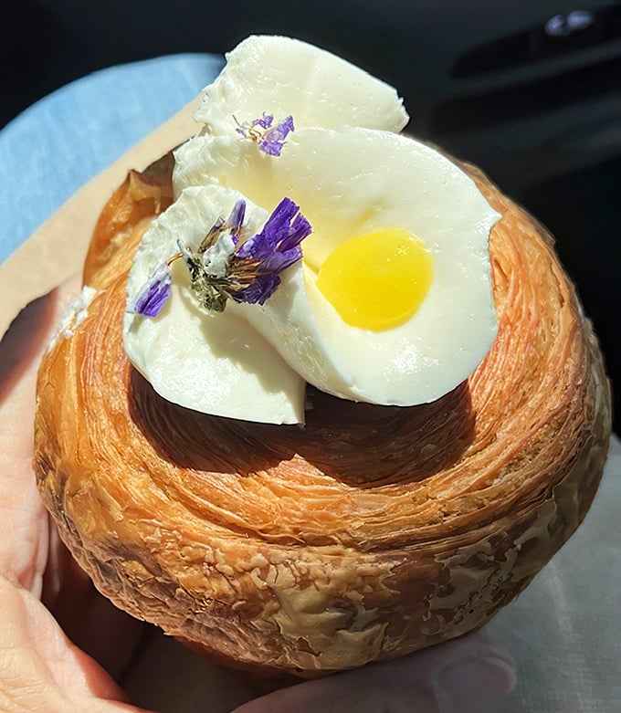 Not just a croissant, not just a muffin—this cruffin with its sunny custard center is the pastry equivalent of hitting the lottery.