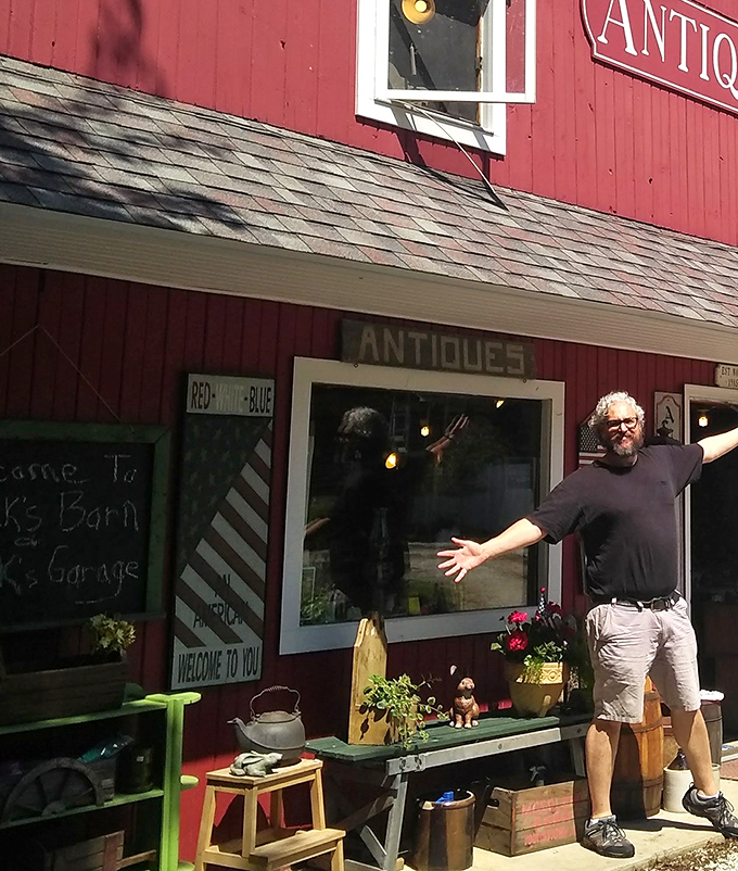 The image shows the exterior of the shop with various outdoor displays arranged along the front of the red building.