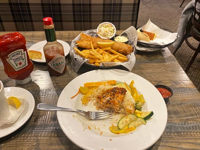 A plate that celebrates simplicity: perfectly cooked fish alongside golden fries and fresh vegetables—no foam or fancy drizzles required.
