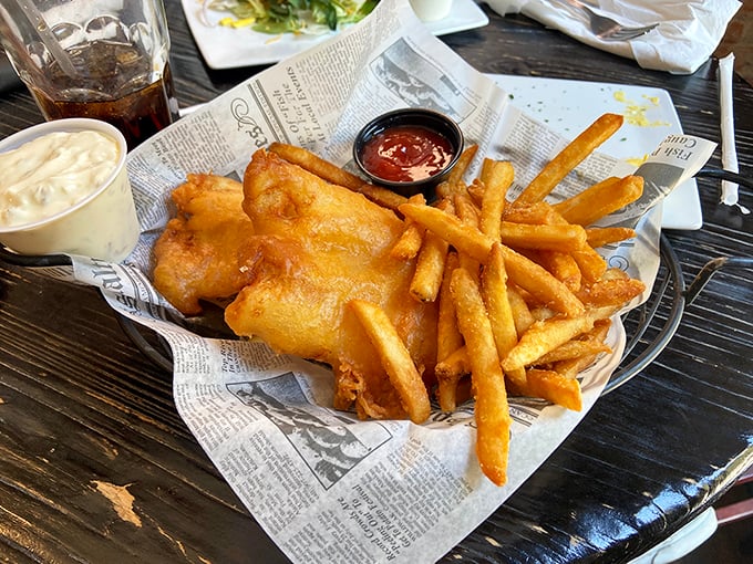 Fish and chips served on newspaper—a crispy, golden reminder that sometimes the simplest foods are the hardest to perfect.