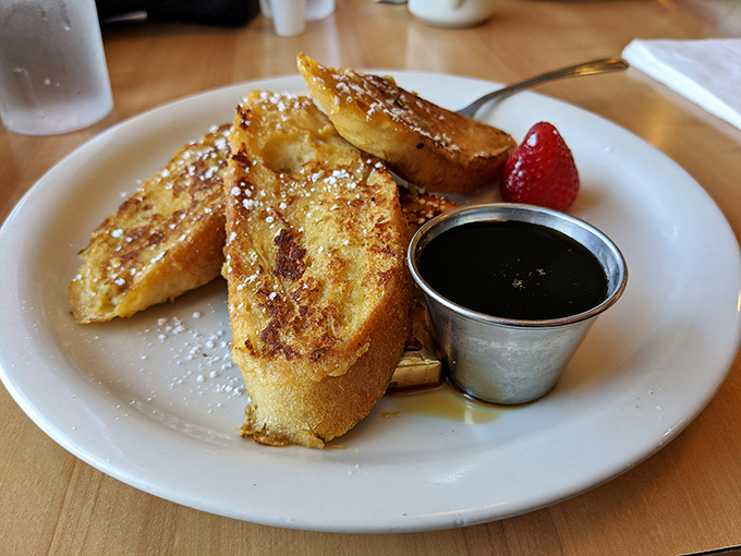 French toast that's achieved the impossible balance—crispy edges, custardy center, and just enough powdered sugar to make you feel like royalty.