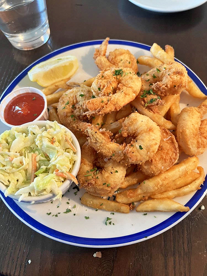 The fried shrimp platter isn't just a meal, it's a celebration—golden treasures from the deep paired with crisp fries and tangy slaw.