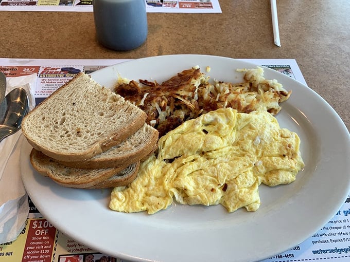 A plate that screams "good morning" louder than your alarm clock—fluffy scrambled eggs and home fries that actually taste like potatoes.