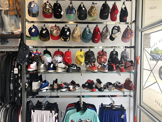 The hat and sneaker display that makes you wonder if you've stumbled into a hypebeast convention rather than a secondhand store.