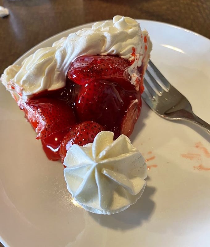 This strawberry pie isn't just dessert—it's a sweet celebration topped with clouds of whipped cream that would make angels jealous.