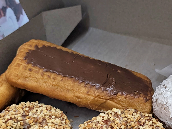 The chocolate long john – half dessert, half religious experience – sits alongside its nutty companions like edible works of art.