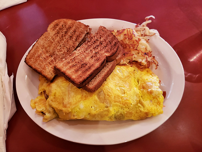 This omelet doesn't just sit on the plate—it lounges confidently, knowing it's about to make your day substantially better.