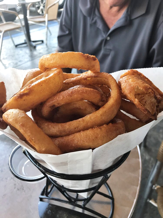 Golden rings of happiness that crunch like a satisfying plot twist. These aren't just onion rings—they're edible jewelry for your taste buds.