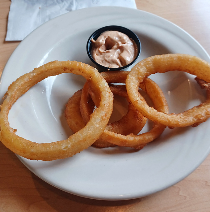Golden halos of crispy perfection. These onion rings achieve that mythical balance between substantial crunch and tender interior that lesser establishments can only dream about.