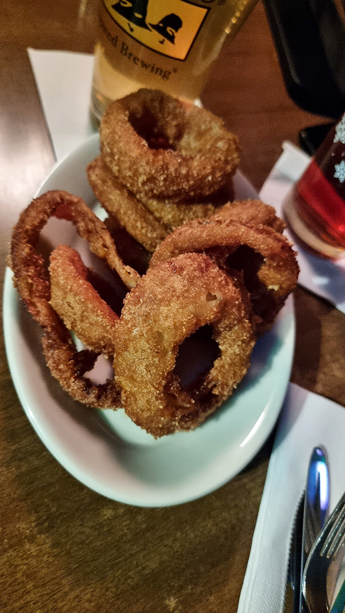 Golden halos of deliciousness! These aren't your average onion rings—they're crunchy, substantial circles of joy that make you question why you'd ever settle for lesser rings.