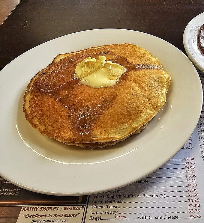 These aren't just pancakes – they're fluffy golden discs of pure morning happiness waiting to happen.