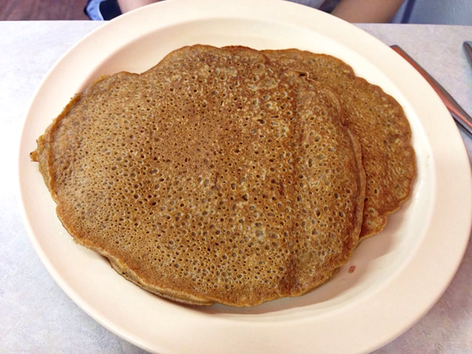 These pancakes could teach a masterclass in fluffiness – golden discs of morning happiness stacked high.