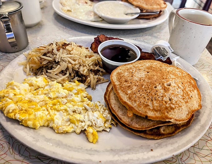 Breakfast platters that could fuel a Mississippi riverboat crew. Those scrambled eggs and pancakes aren't just food—they're edible sunshine on a plate.