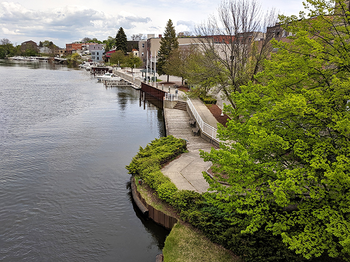 The Manistee Riverwalk curves gracefully, inviting leisurely strolls that justify every ice cream cone along the way.