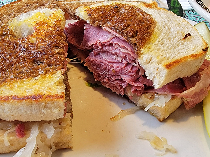 The legendary pastrami sandwich in all its glory—layers of pink perfection nestled between toasted rye. This is what food dreams are made of.