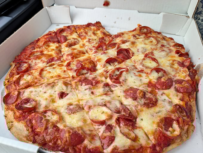 This pepperoni pizza isn't trying to reinvent the wheel—it's just perfecting it with those gloriously curled, crisp-edged pepperoni cups holding liquid gold.