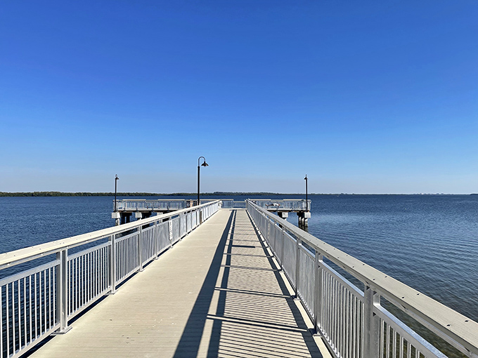 This pristine fishing pier stretches toward endless horizons. It's not just a place to cast a line—it's where time slows to a perfect standstill.