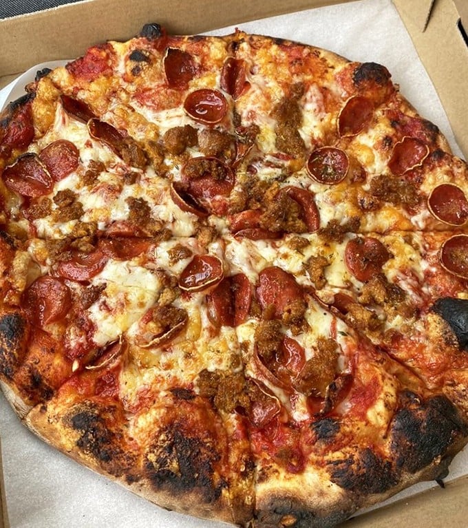 Wood-fired pizza that makes you question every delivery order you've ever placed. Those char marks aren't mistakes—they're flavor autographs from the fire gods.