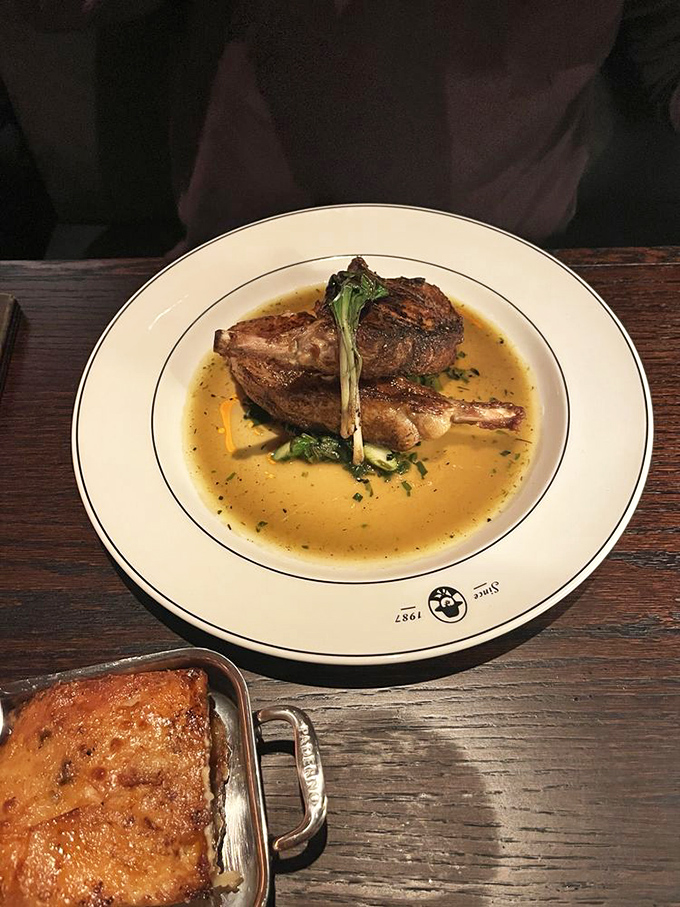 This pork chop isn't just dinner—it's floating in a savory pond of jus that you'll be tempted to drink with a straw when nobody's looking.