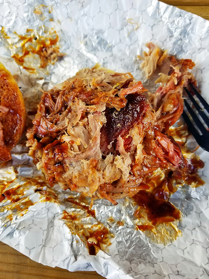 Pulled pork that doesn't just fall apart—it surrenders completely. This isn't just meat; it's a time capsule of smoke, patience, and barbecue wisdom.
