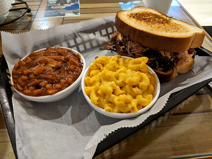The pulled pork sandwich arrives with sides that aren't afterthoughts but co-stars—mac and cheese that's actually cheesy and baked beans with substance.