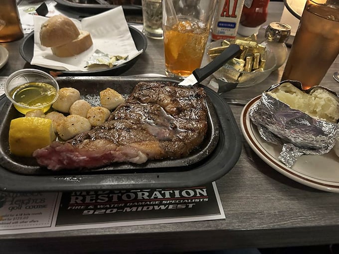 A steak, some scallops, and an old-fashioned—the holy trinity of Wisconsin supper club worship, served on the traditional sizzling platter altar.