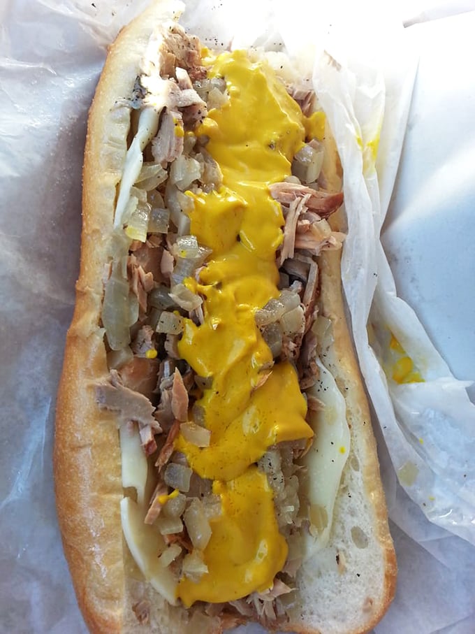 Cheese cascades like a golden waterfall over thinly chopped meat. This is Philadelphia's version of comfort in sandwich form.