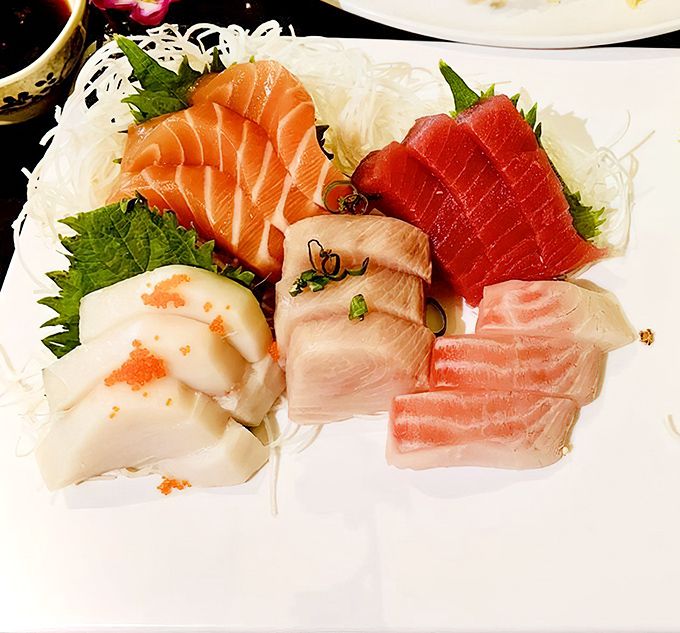 A sashimi platter that's practically a work of art – each slice of fish positioned with the precision of a diamond cutter.