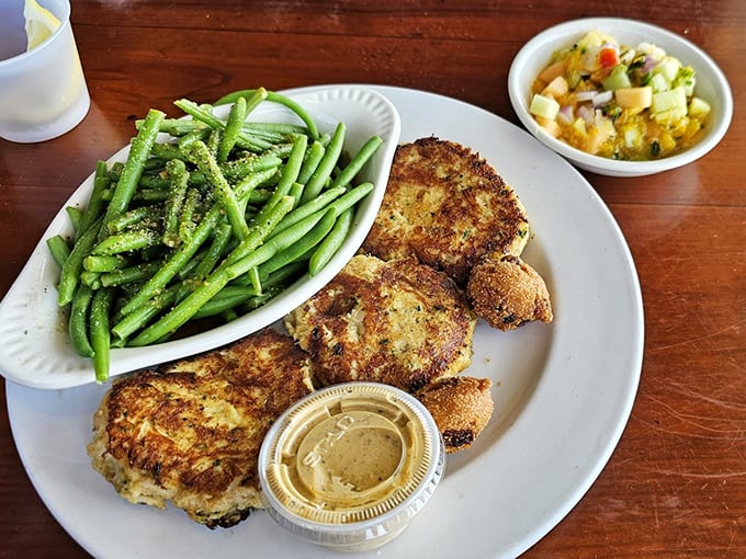 These seared crab cakes aren't playing around – golden-brown perfection paired with green beans that somehow make you feel virtuous while indulging.
