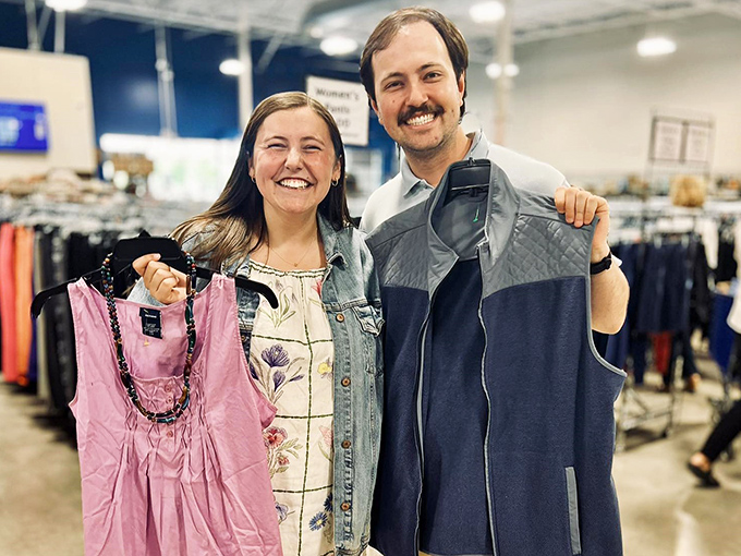 The universal thrift store victory pose – holding up your finds like Olympic medals. These shoppers just struck gold in the fashion department.