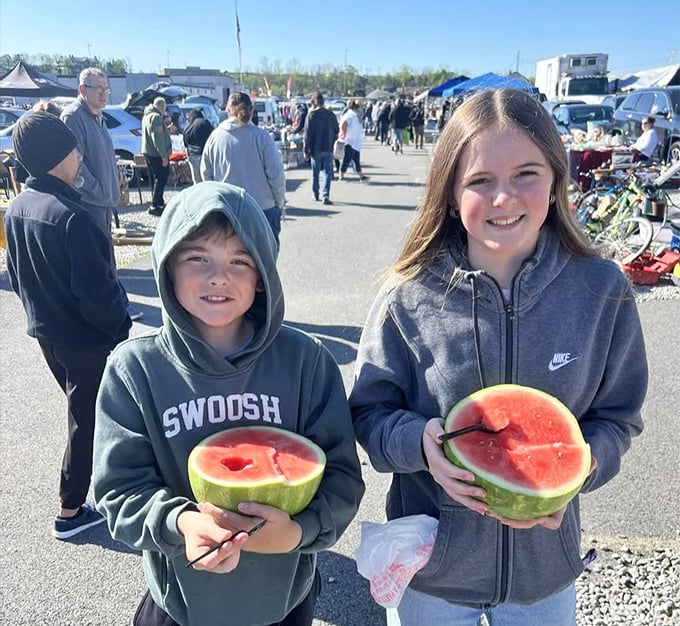 Nothing beats fresh watermelon on flea market day. These young shoppers have mastered the art of snacking while treasure hunting.