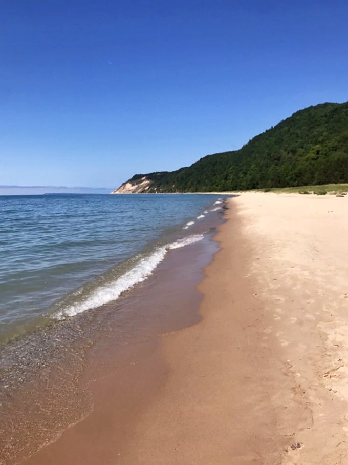 That moment when you realize the Caribbean has been jealous of Michigan all along. Crystal waters kiss golden shores beneath dramatic bluffs.
