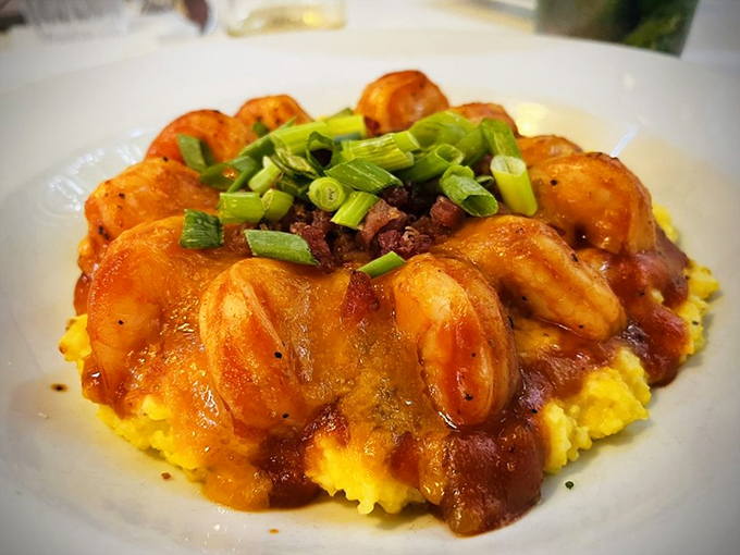 The legendary shrimp and grits—a golden pool of creamy cornmeal cradling plump shrimp and bacon, like a Lowcountry lullaby on a plate.