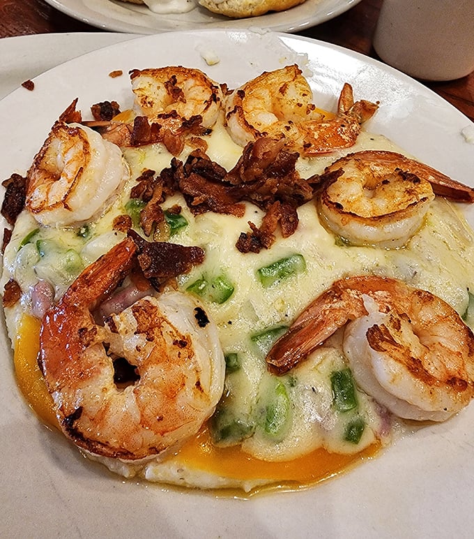 Shrimp and grits elevated to an art form – plump shrimp, crispy bacon, and creamy grits creating a symphony of Southern flavors.