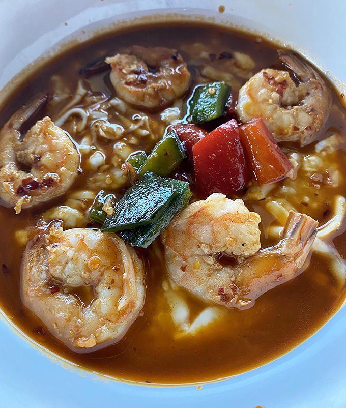 The shrimp and grits whisper sweet nothings to your taste buds. Those colorful peppers aren't just for show—they're bringing the party.