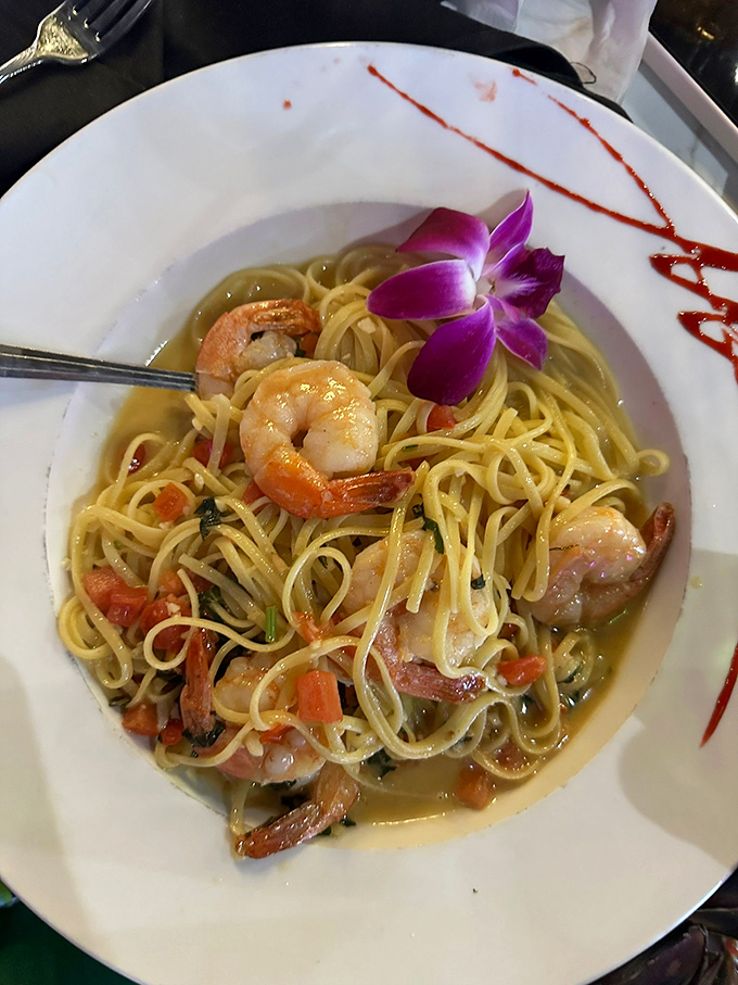 Pasta playing the supporting role to plump shrimp in a delicate sauce – with that edible purple flower saying "Yes, we're fancy, but fun too."