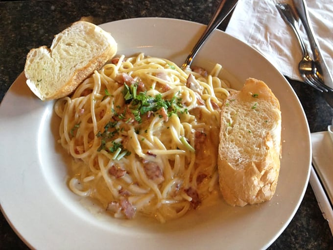 Pasta carbonara that would make Romans weep with joy—silky strands embraced by a creamy sauce with pancetta playing the delicious supporting role.
