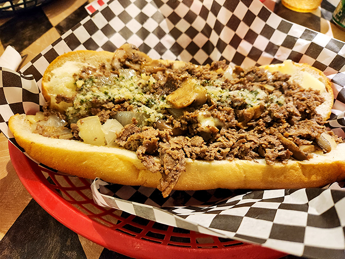 Behold the mighty cheesesteak in its natural habitat. That golden roll cradles seasoned meat and melted cheese like a mother holding her newborn sandwich baby.
