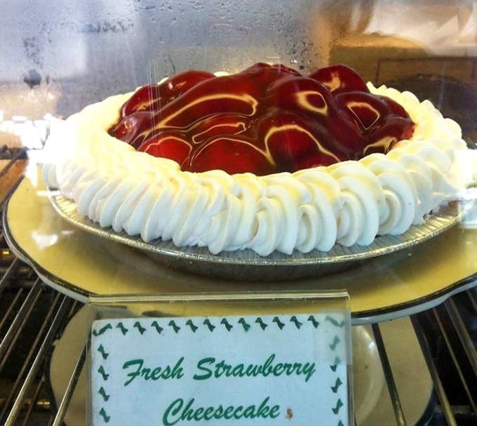The strawberry cheesecake wears its glossy red topping like a prom queen's tiara—confident, a bit showy, and absolutely deserving of the attention.