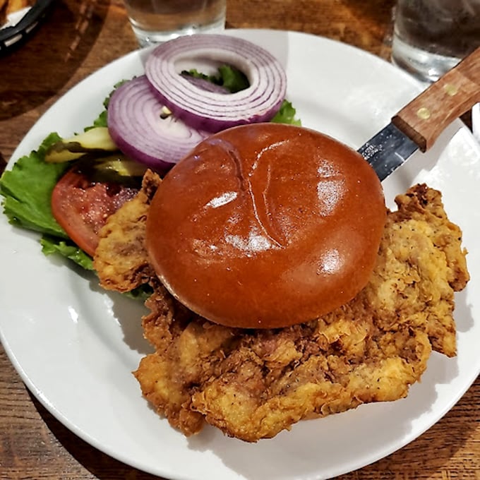 This isn't just a chicken sandwich – it's a golden-fried masterpiece on a gleaming bun, with crisp veggies standing by for moral support.