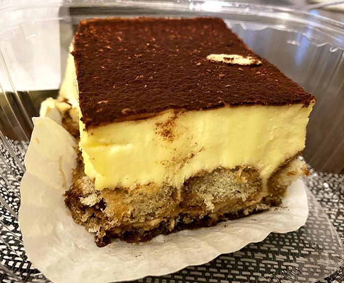 This tiramisu isn't just a dessert, it's an engineering marvel—layers of coffee-soaked ladyfingers and mascarpone cream supporting that perfect chocolate roof.