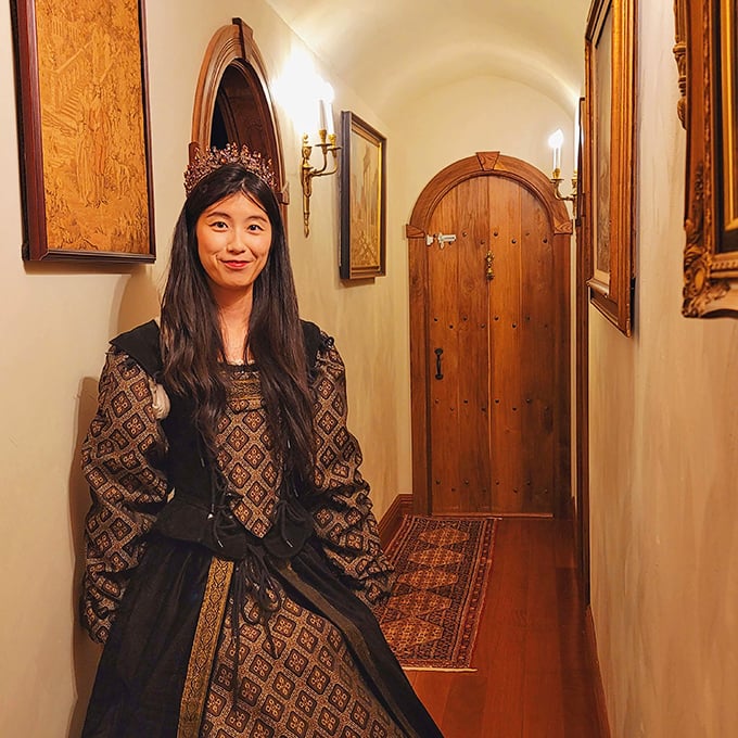 The hallway features elegant arched doorways and warm lighting that transforms an ordinary corridor into a passage through centuries.