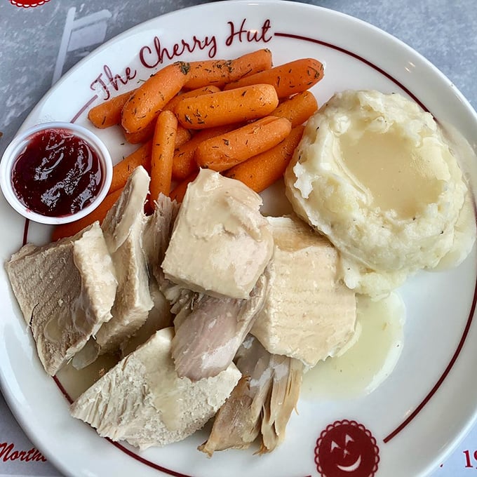 Turkey dinner with all the fixings – proof that Thanksgiving doesn't need to wait for November. That cherry sauce on the side? Game-changer.