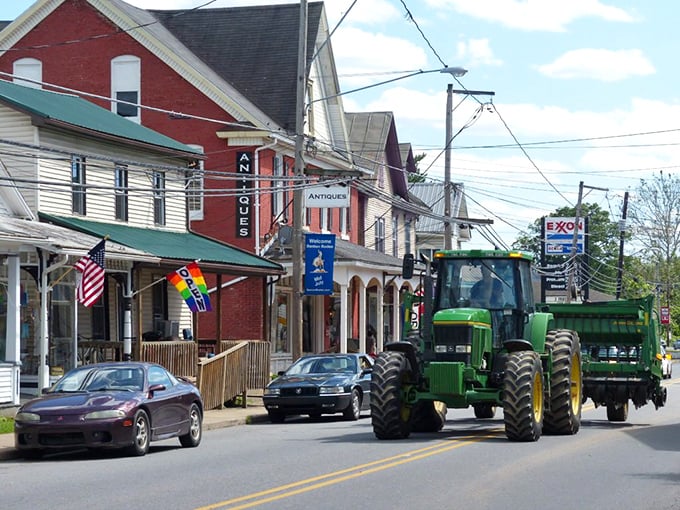 A tractor rolling past antique shops—Benton perfectly blends farm life with small-town charm and friendly storefronts on a sunny afternoon.