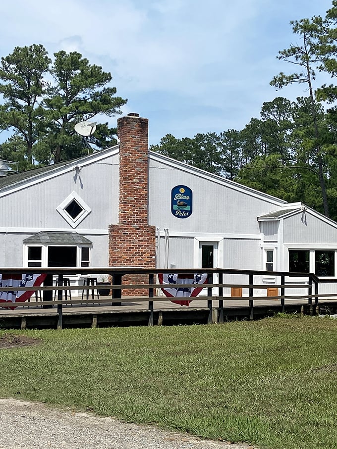 Blue Pete's rustic white exterior and brick chimney look like they belong in a storybook about perfect waterside dining. 