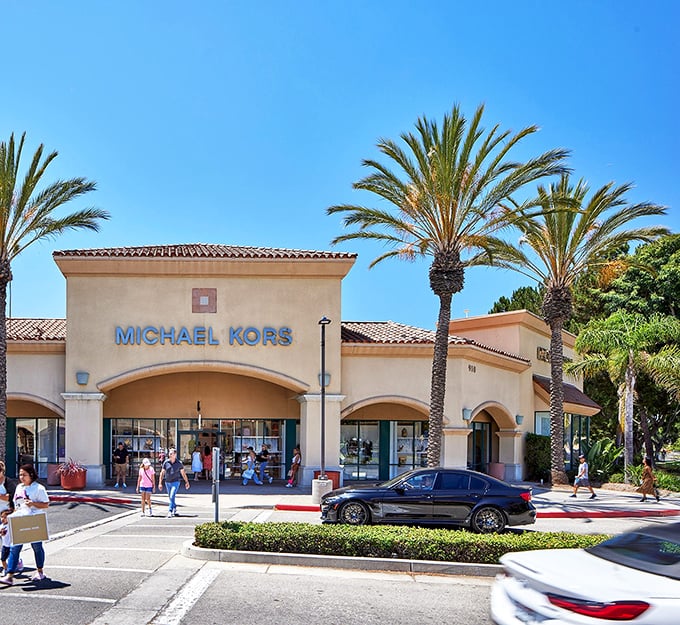 Michael Kors basks in California sunshine, tempting shoppers with luxury bags at prices that won't require a second mortgage.