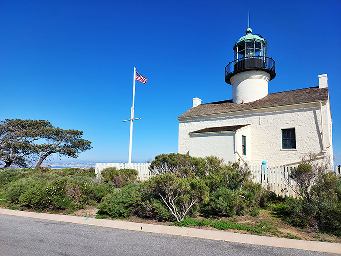Old Point Loma's pristine white tower has witnessed centuries of maritime history – if only these walls could talk!