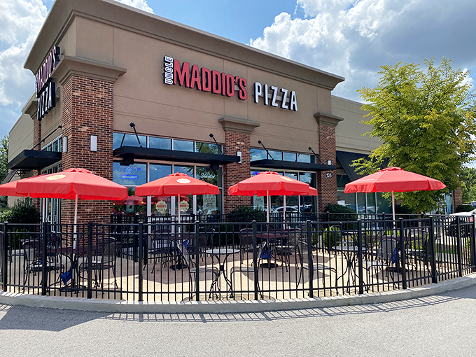 Uncle Maddio's welcoming patio with bright red umbrellas – the perfect stage for their pizza masterpieces.